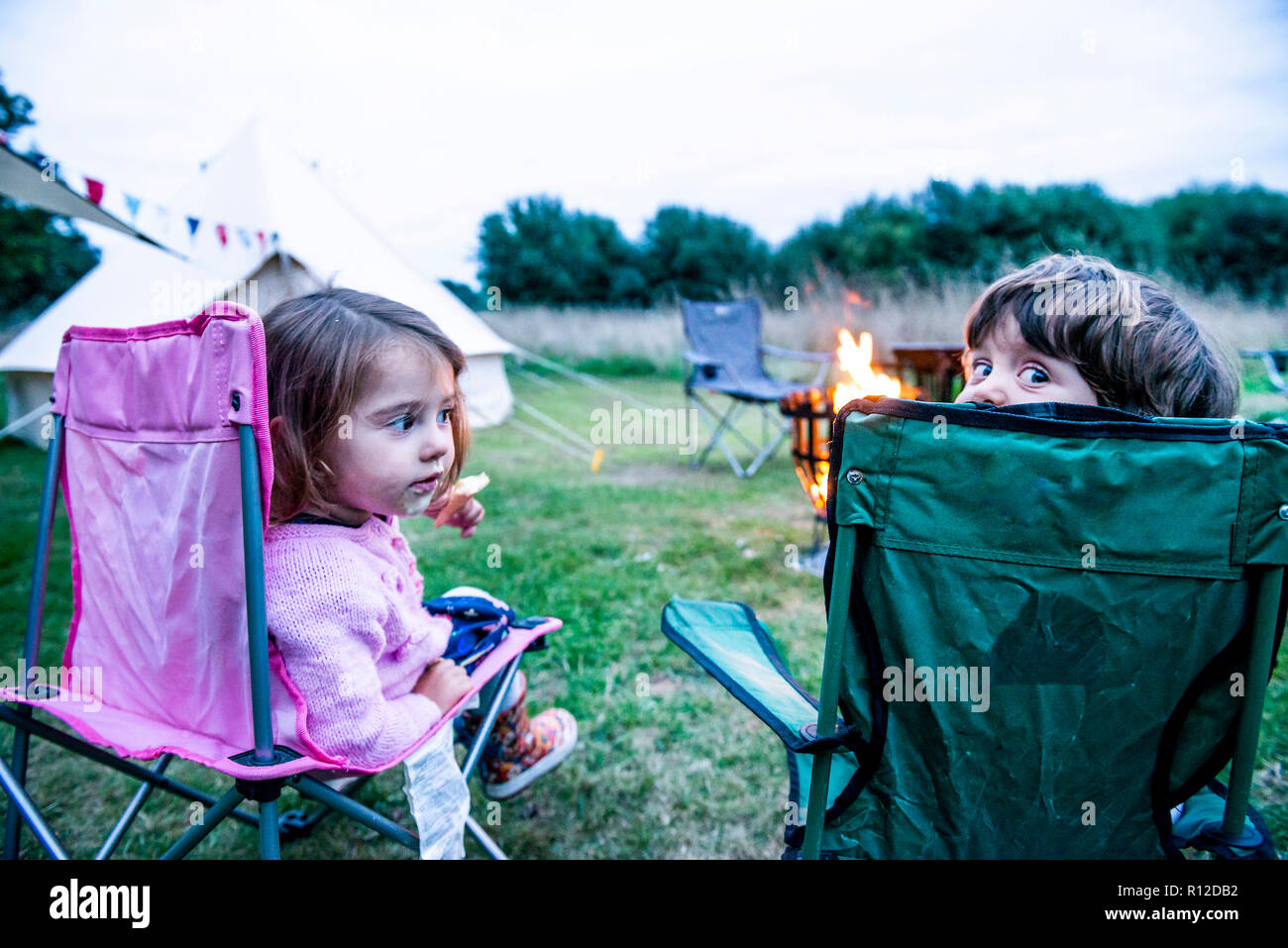 Children relaxing in front of bonfire Stock Photo - Alamy
