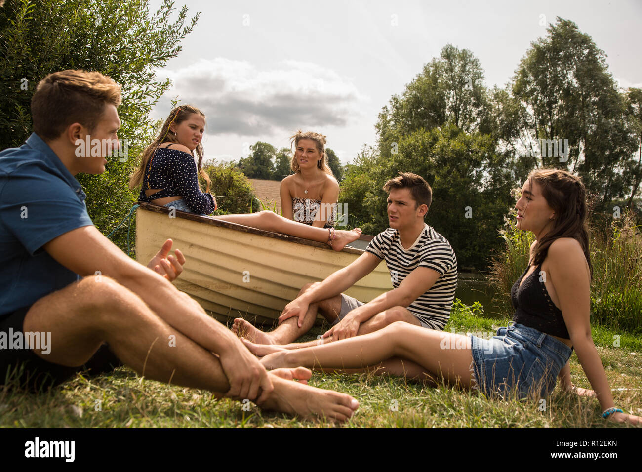 Friends relaxing in park Stock Photo - Alamy
