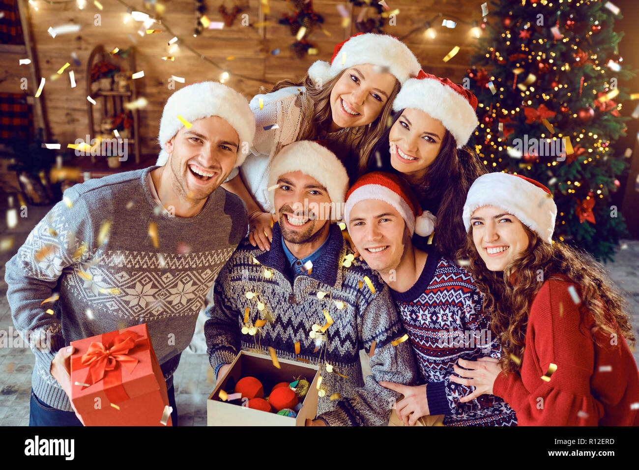 Friends with gifts celebrating Christmas Stock Photo - Alamy