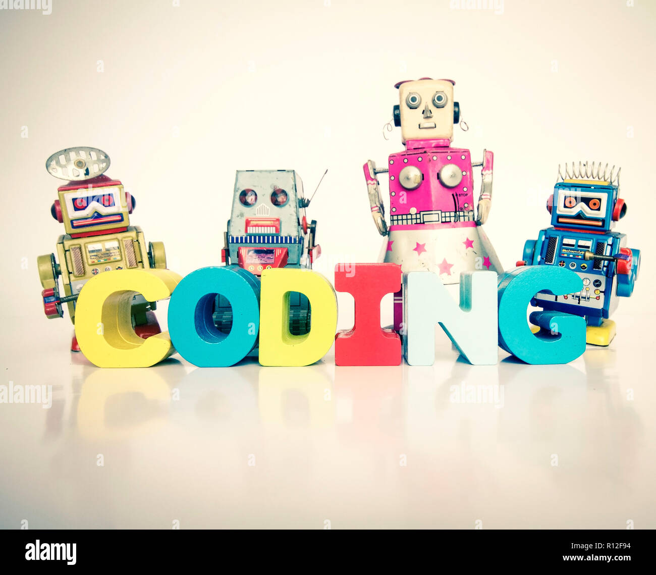 a team of toy robots with the word coding isolated on white Stock Photo ...