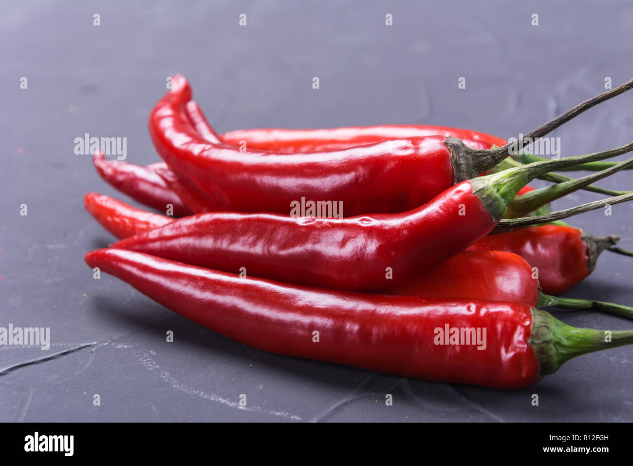 Red spicy chili pepper on dark background Stock Photo - Alamy