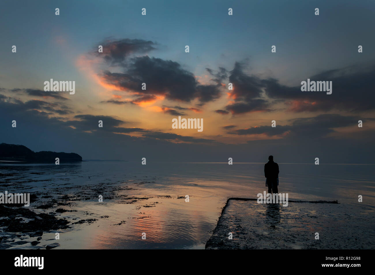 A couple having a cuddle Stock Photo - Alamy