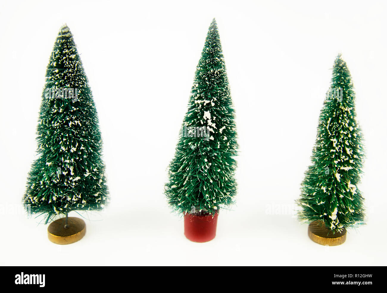 Three plastic Christmas tree on white background Stock Photo - Alamy
