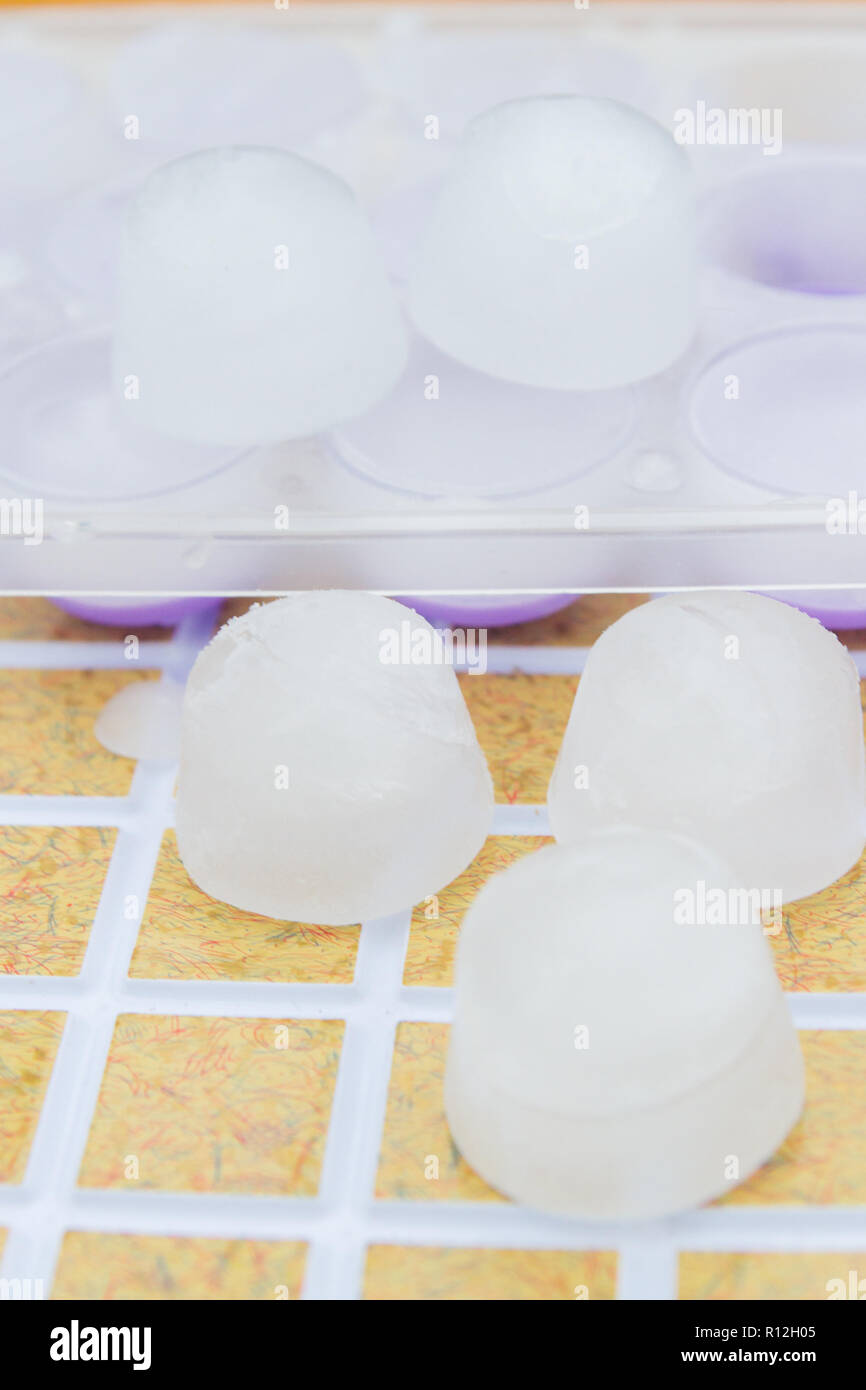 Round the ice in the ice tray purple color Stock Photo - Alamy