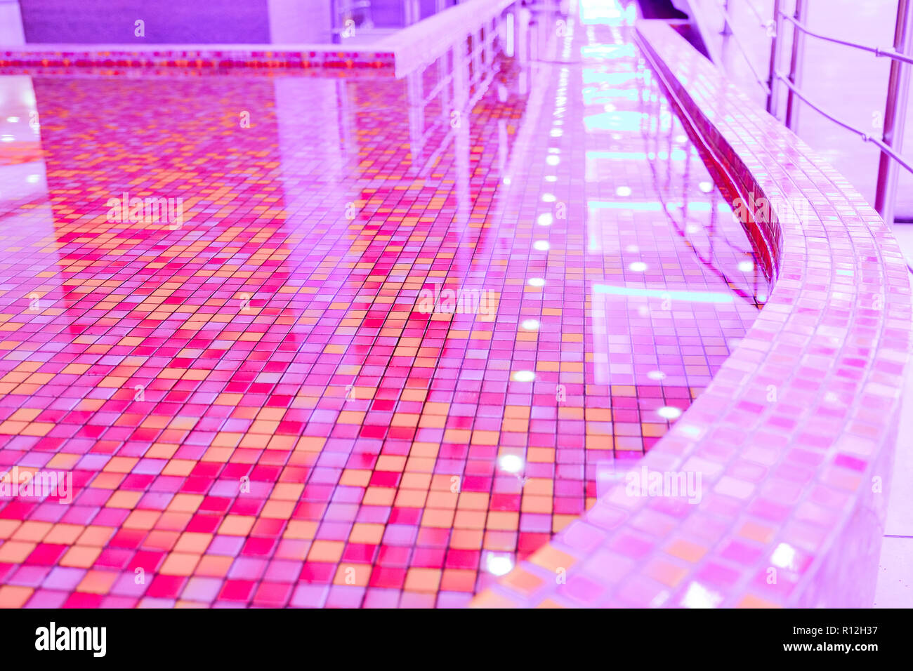 water in the pool with red-orange decorative tiles Stock Photo - Alamy