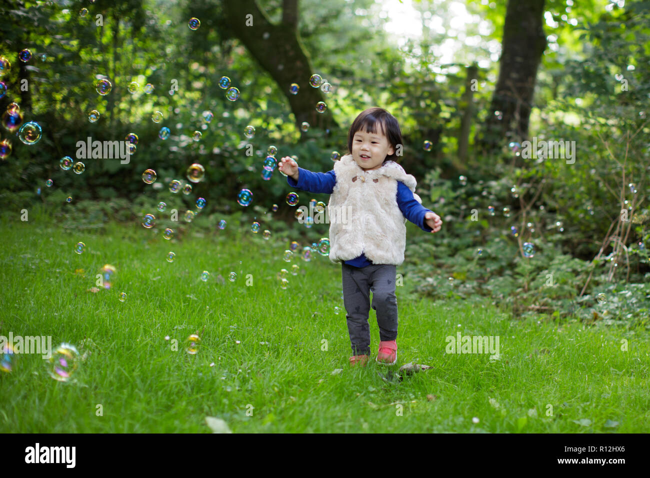toddle baby girl play bubble at Spring garden Stock Photo - Alamy