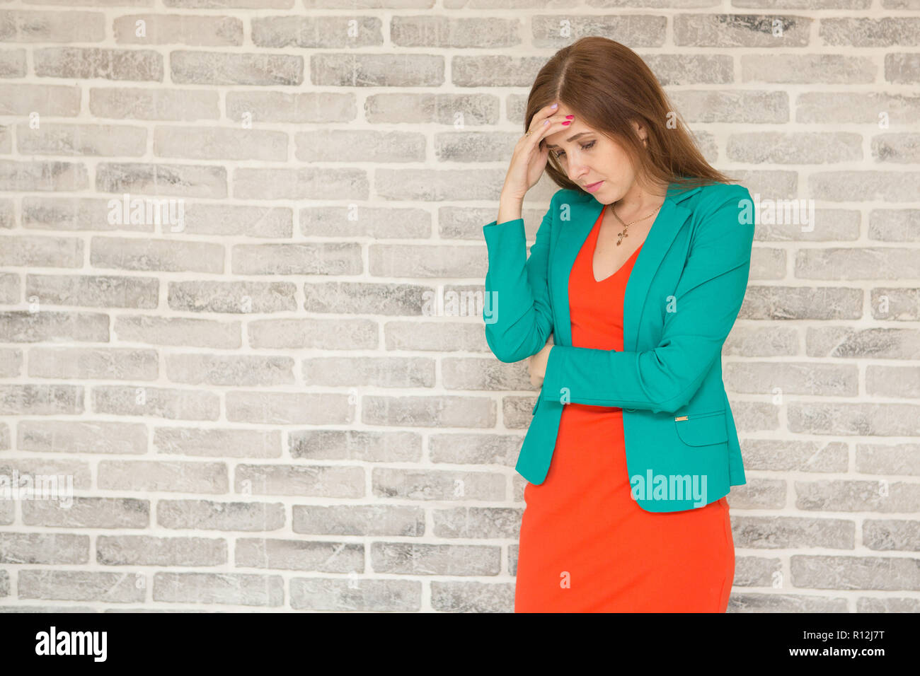Young woman with headache, holding head, sad, sad brooding Stock Photo ...