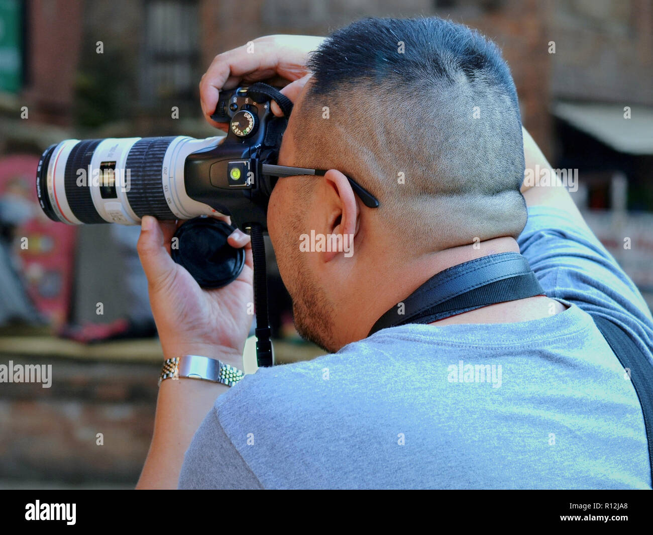 Back portrait of a young, overweight Chinese street photographer Stock ...