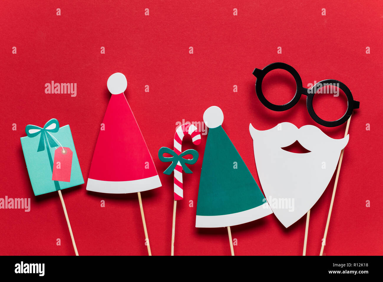 Christmas photo booth props on a red background Stock Photo - Alamy