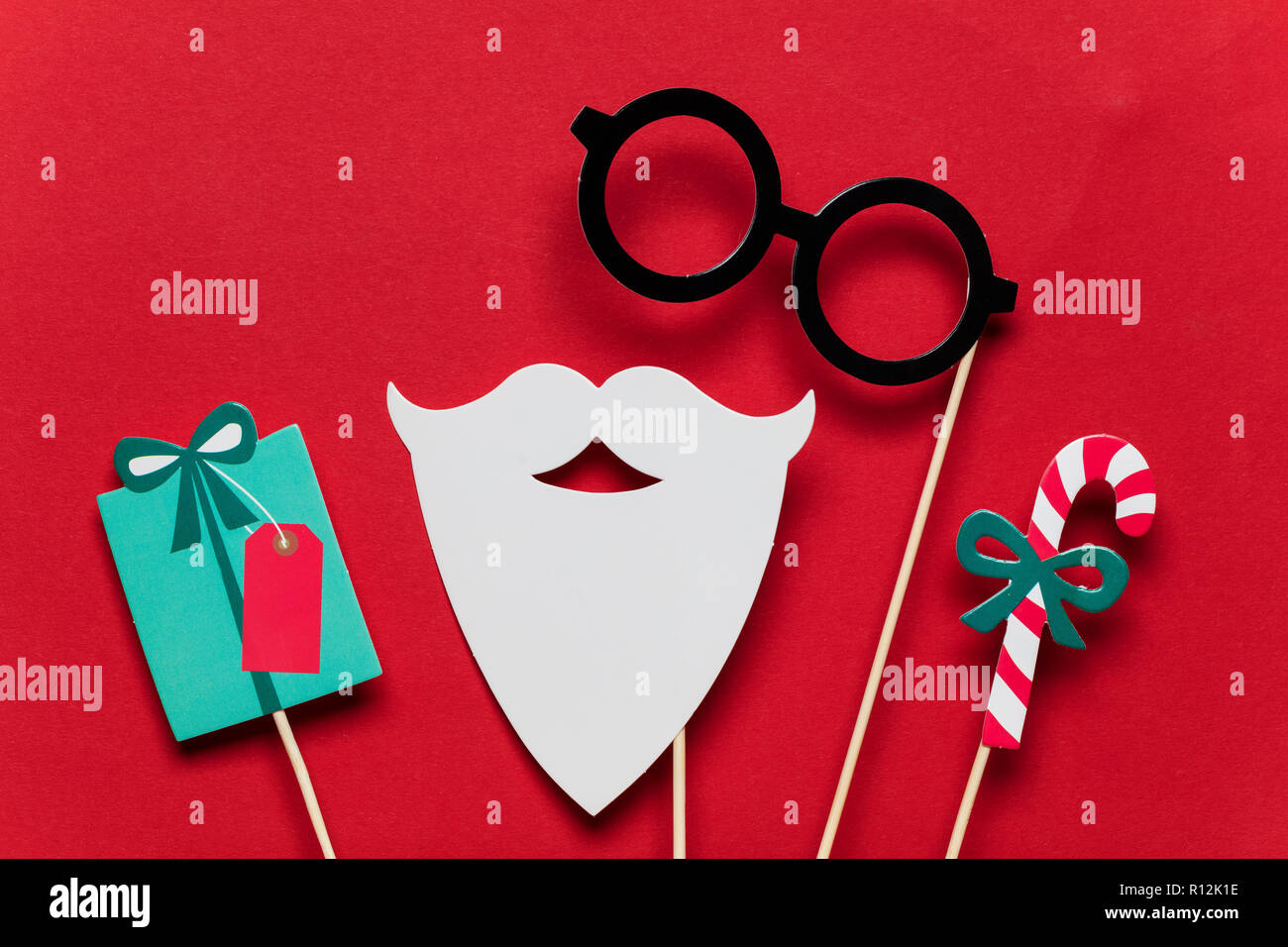 Christmas photo booth props on a red background Stock Photo - Alamy