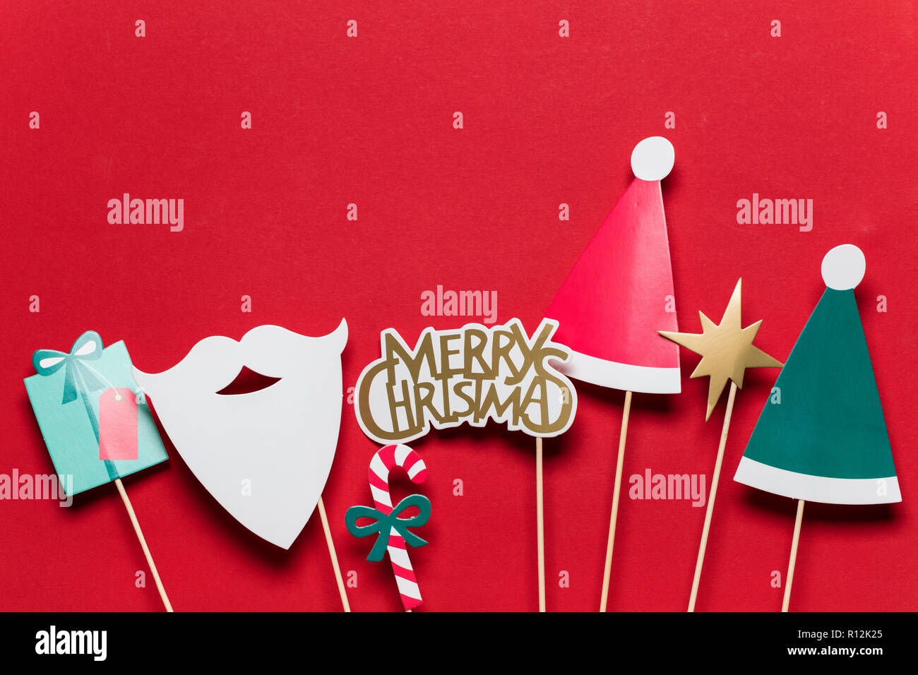 Christmas photo booth props on a red background Stock Photo - Alamy
