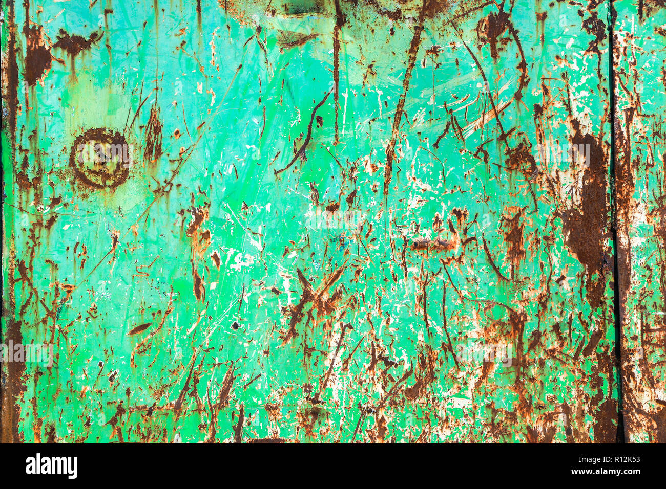 Green rusty and grungy metal iron plate wall with the typical ferric ...