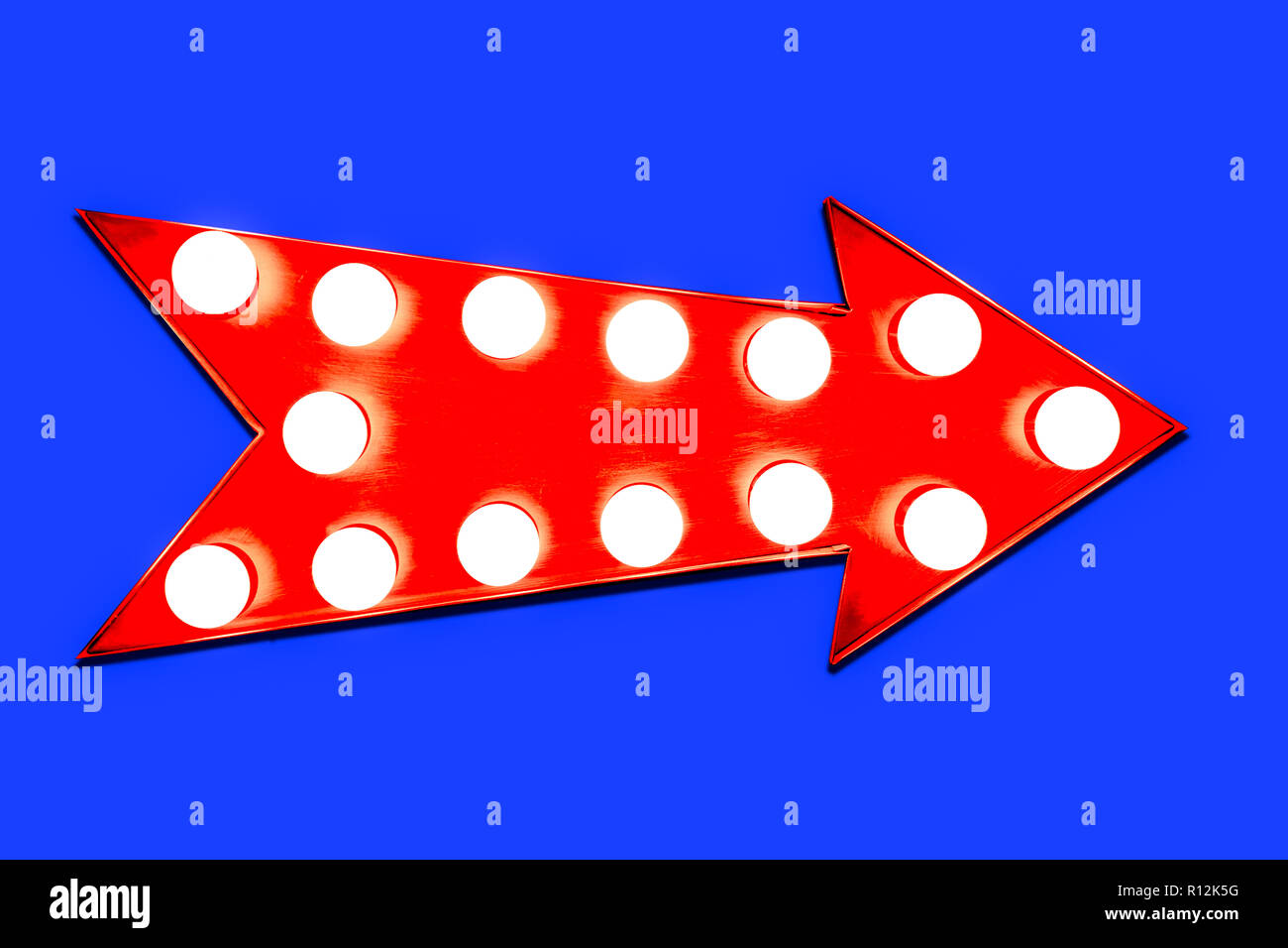 Red arrow shaped vintage colorful illuminated metallic display ...