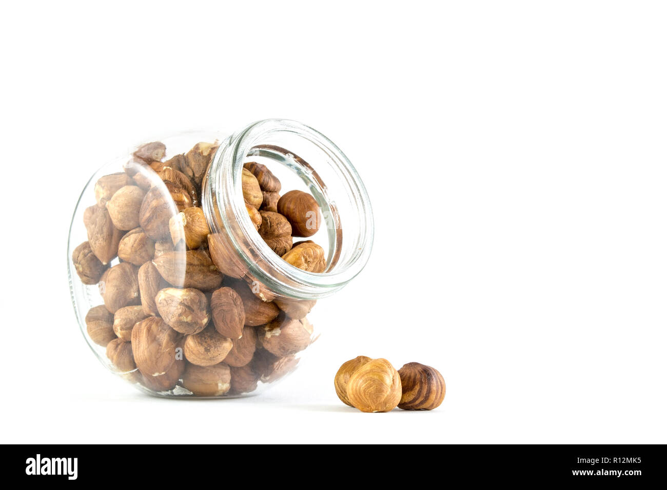 hazelnuts in a glass jar isolated on white background Stock Photo - Alamy