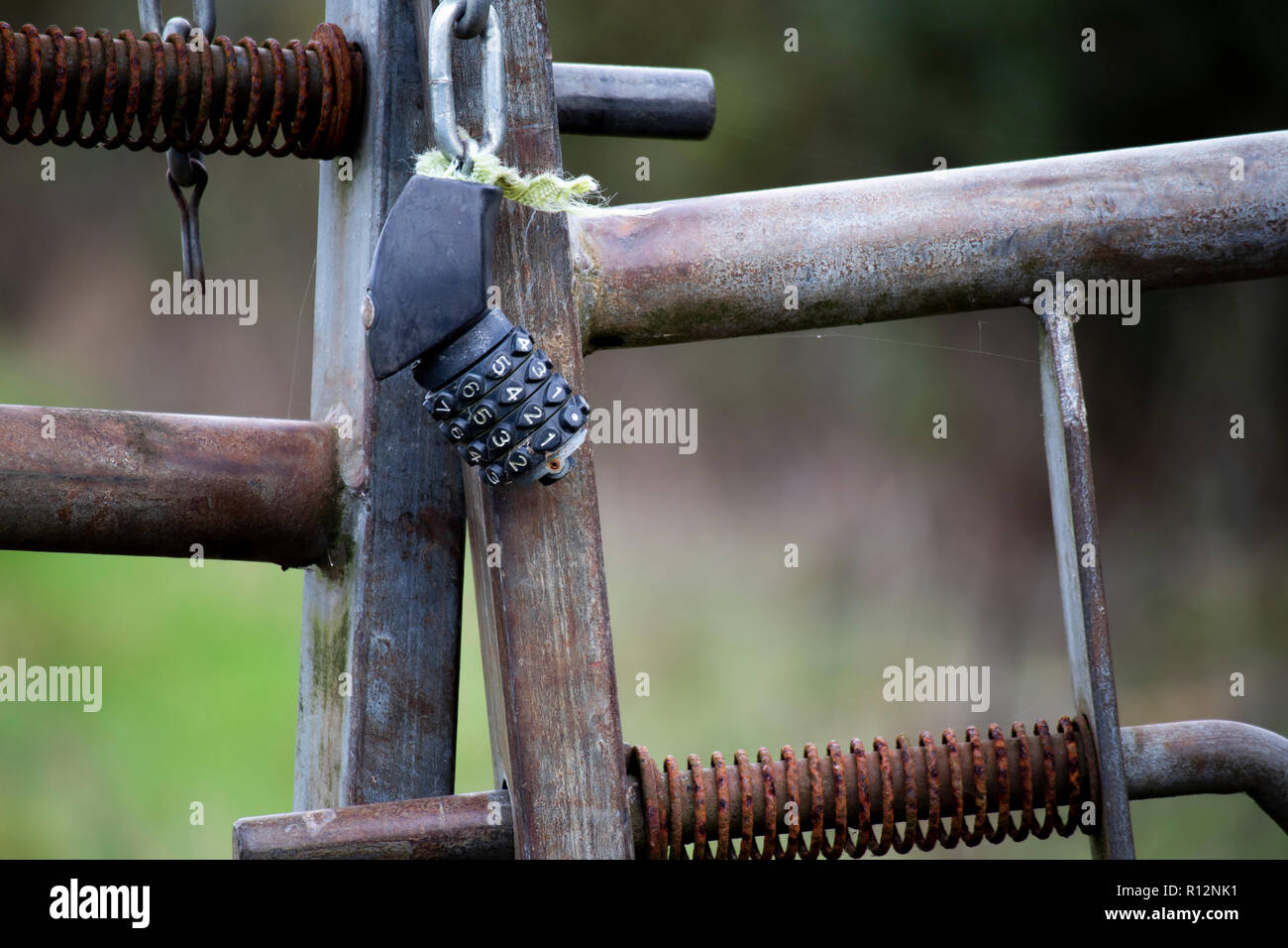 Combination locked metal framed farm gate to farmland in rural ...