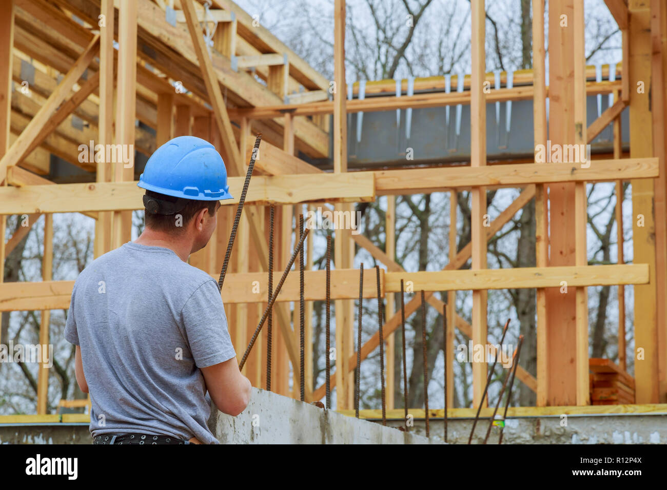 A building inspector surveys a new home build in construction site ...