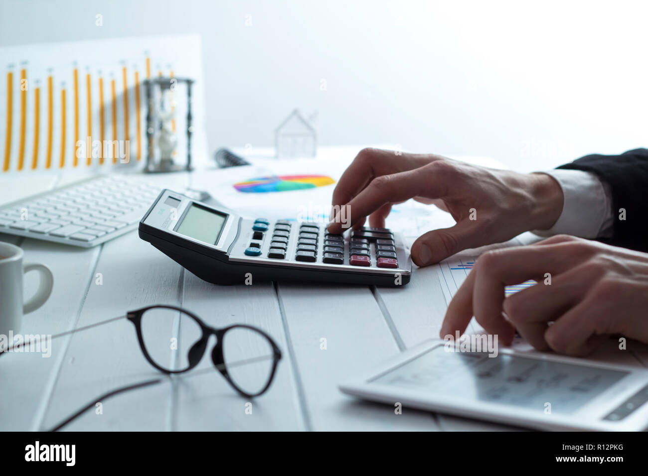 The hands of an accountant work on a calculator and prepare a financial ...