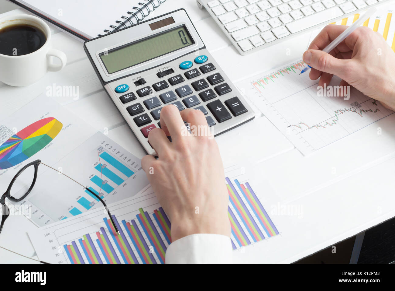 The hands of an accountant work on a calculator and prepare a financial ...