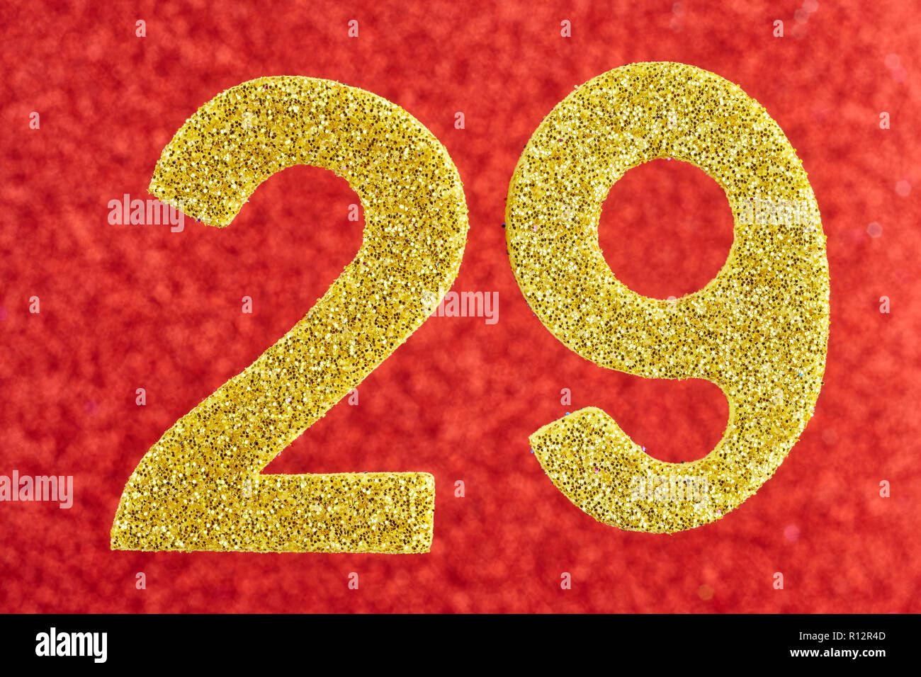 Number twenty-nine golden color over a red background. Anniversary ...