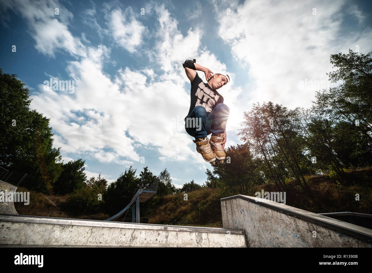 Inline skating jump Stock Photo - Alamy