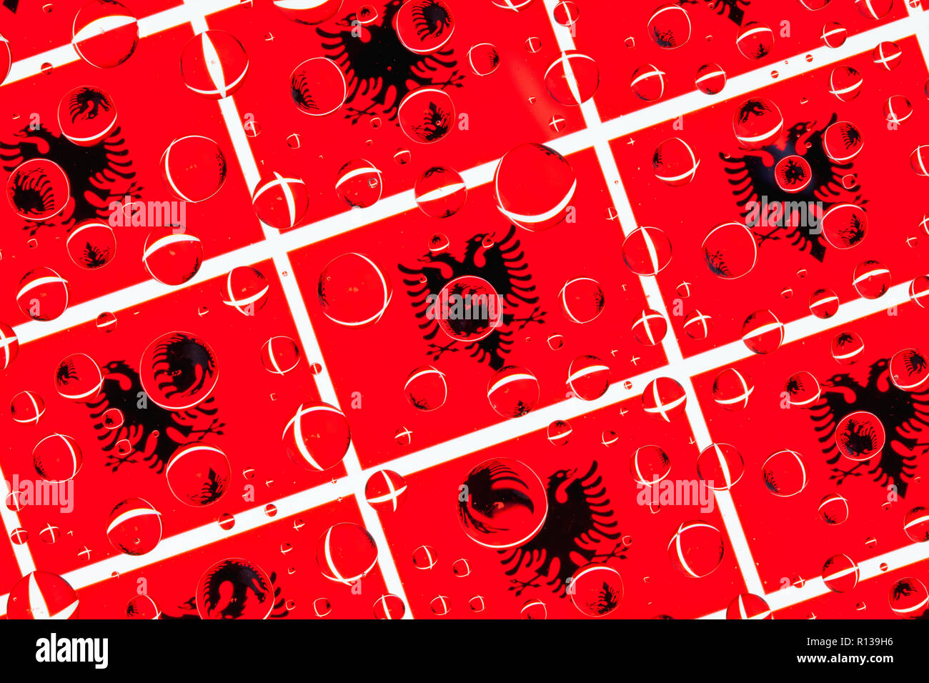 Flags of Albania, behind a glass covered with rain drops.Pattern from ...