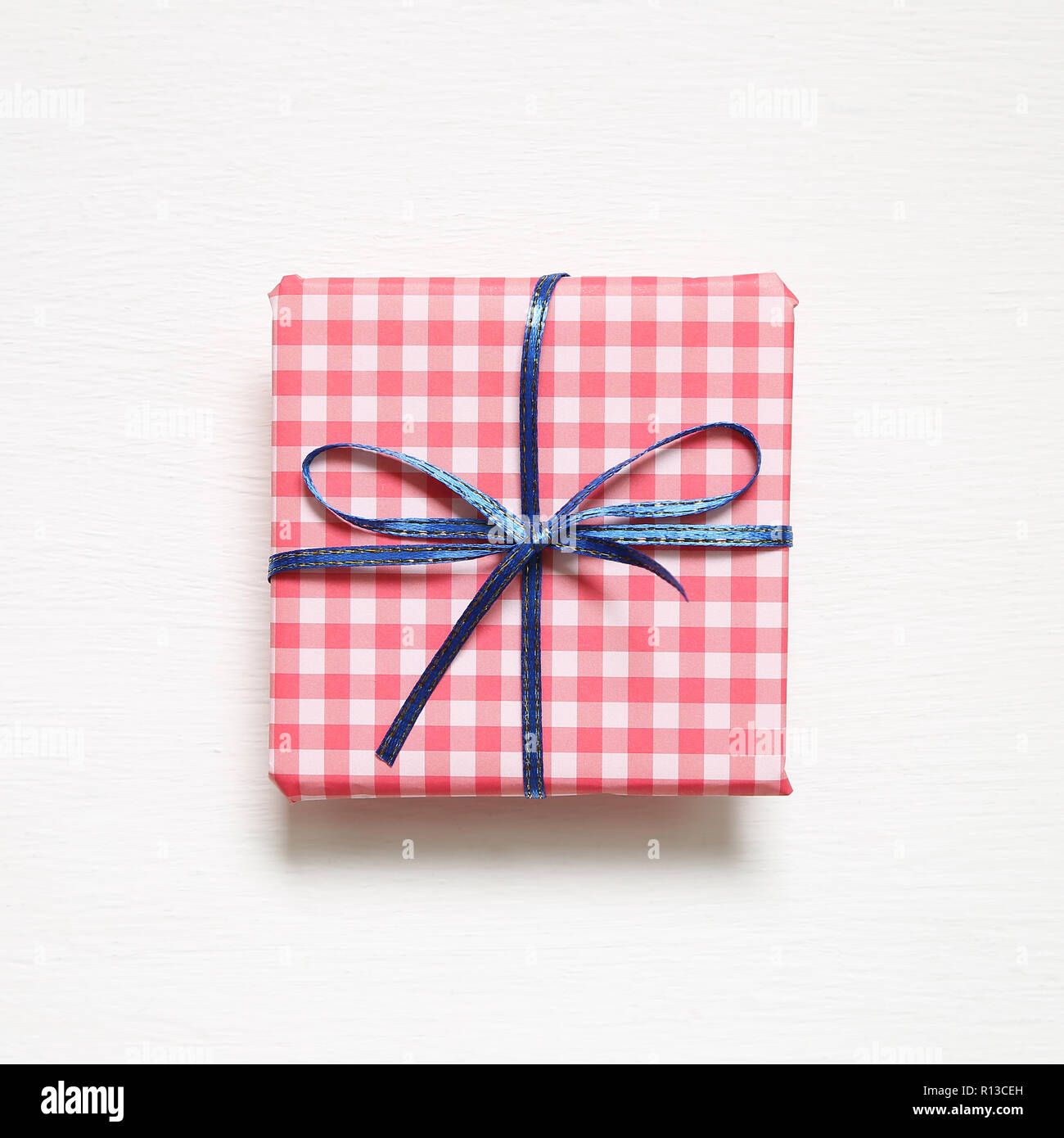 Red check pattern gift box isolated on white background Stock Photo - Alamy