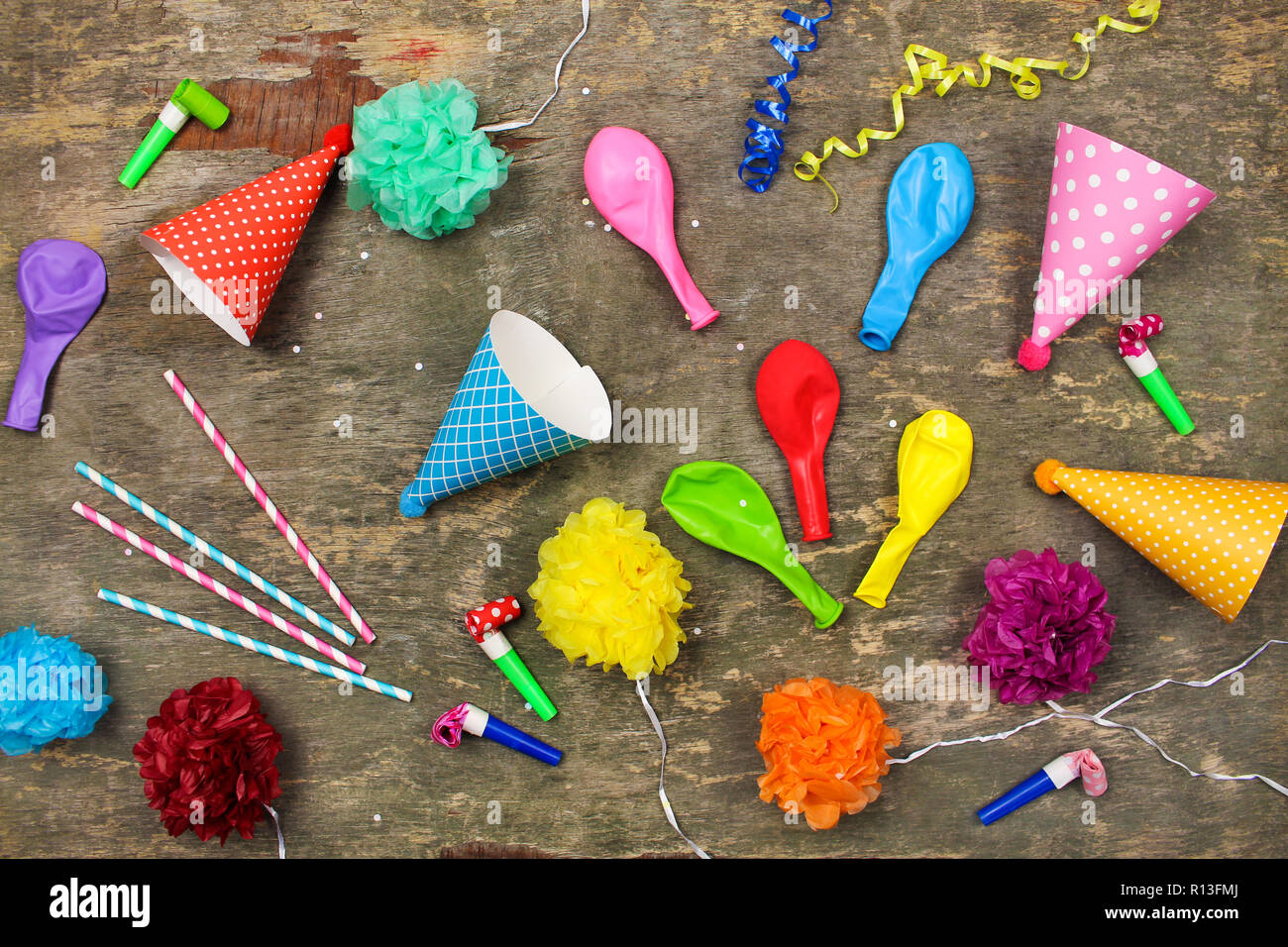 Holiday hats, whistles, balloons on old wooden background. Concept of ...
