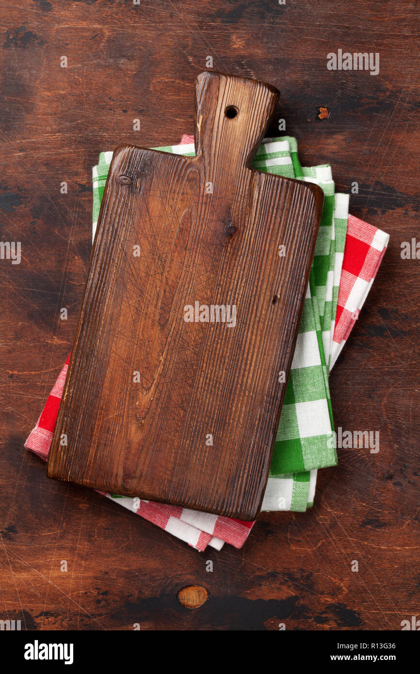 Cooking wooden table with cutting board over kitchen towel or napkin ...