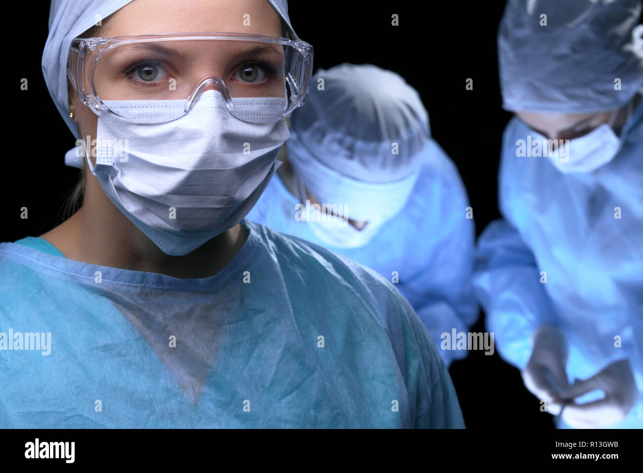 Medical team performing operation. Focus at female doctor Stock Photo ...