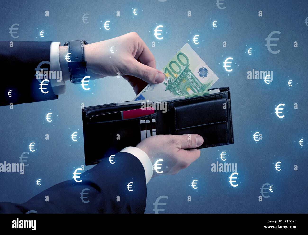 Businessman's hand takes out euro from a wallet with euro symbol ...