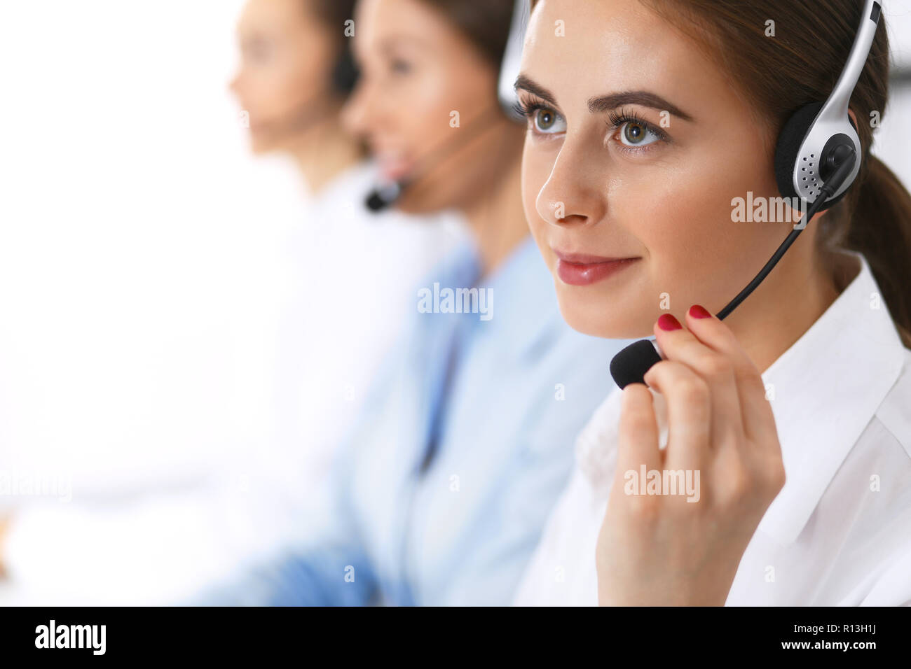 Call center. Group of operators at work. Focus on beautiful business ...