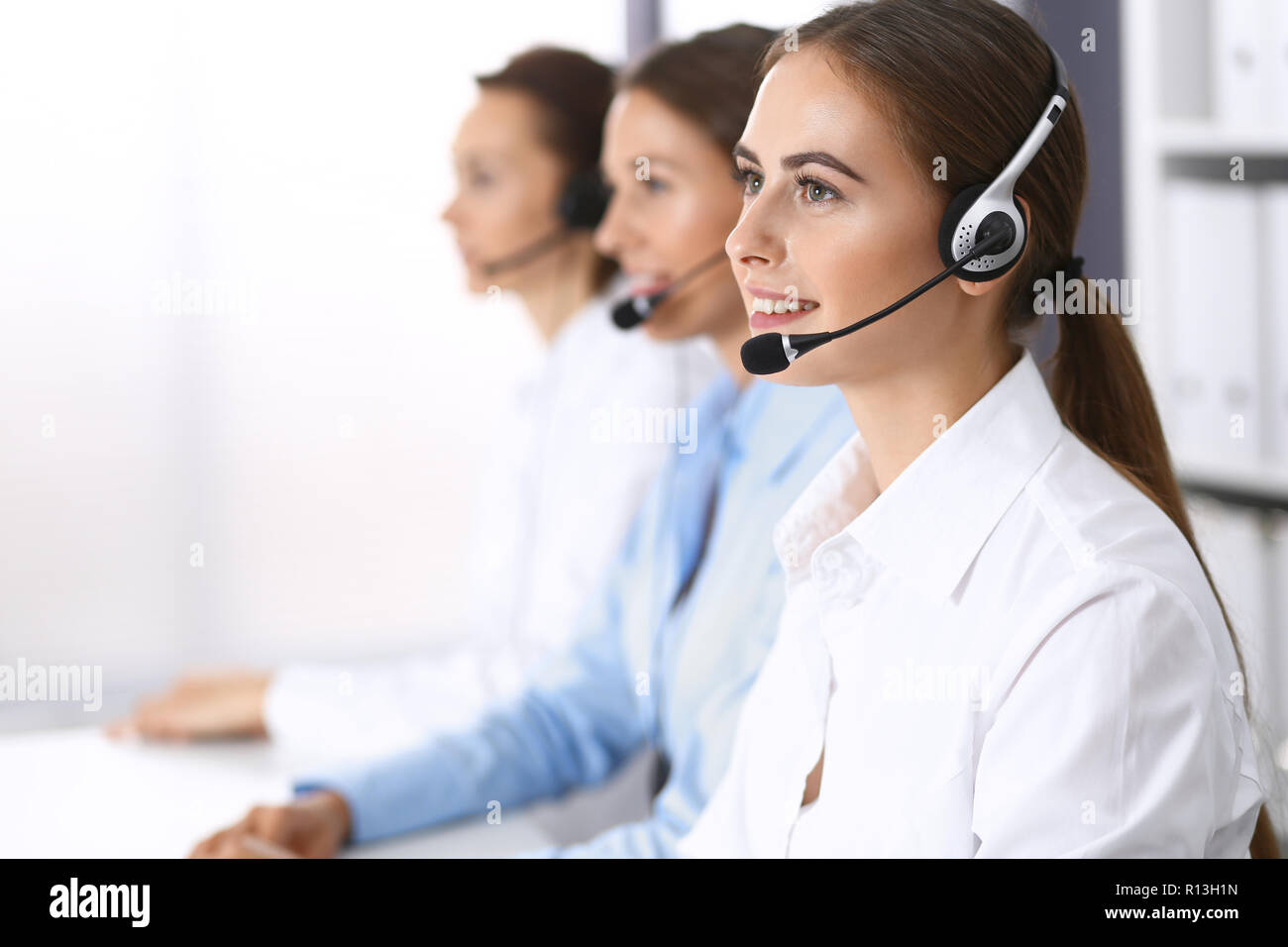 Call center. Group of operators at work. Focus on beautiful business ...