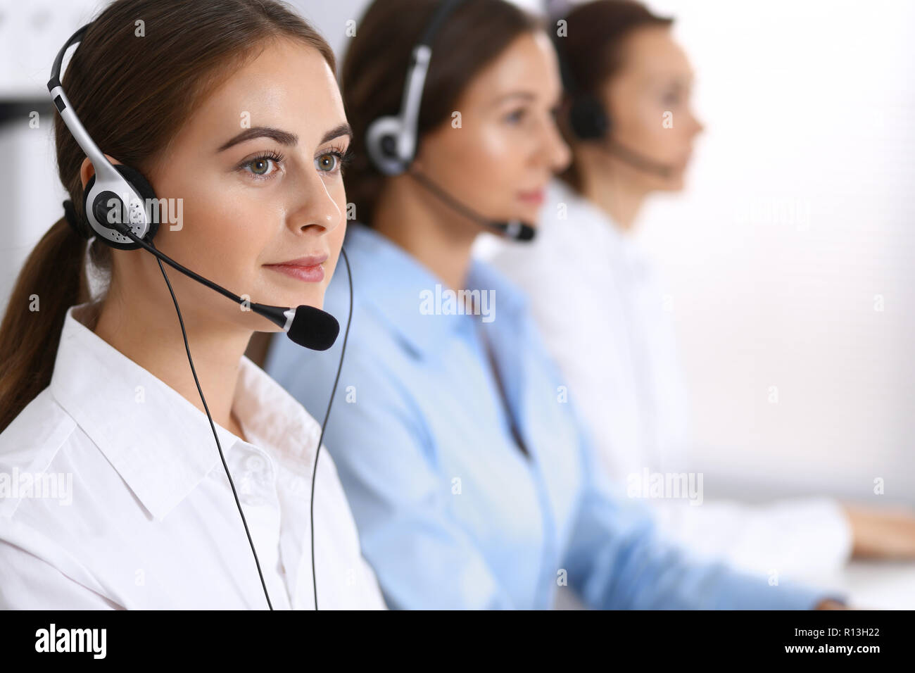 Call center. Group of operators at work. Focus on beautiful business ...