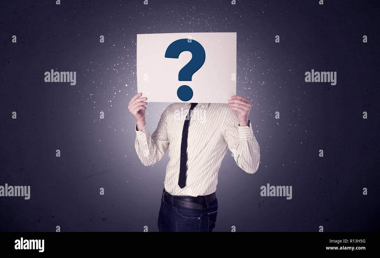Young businessman hiding behind a question mark drawn on paper Stock ...