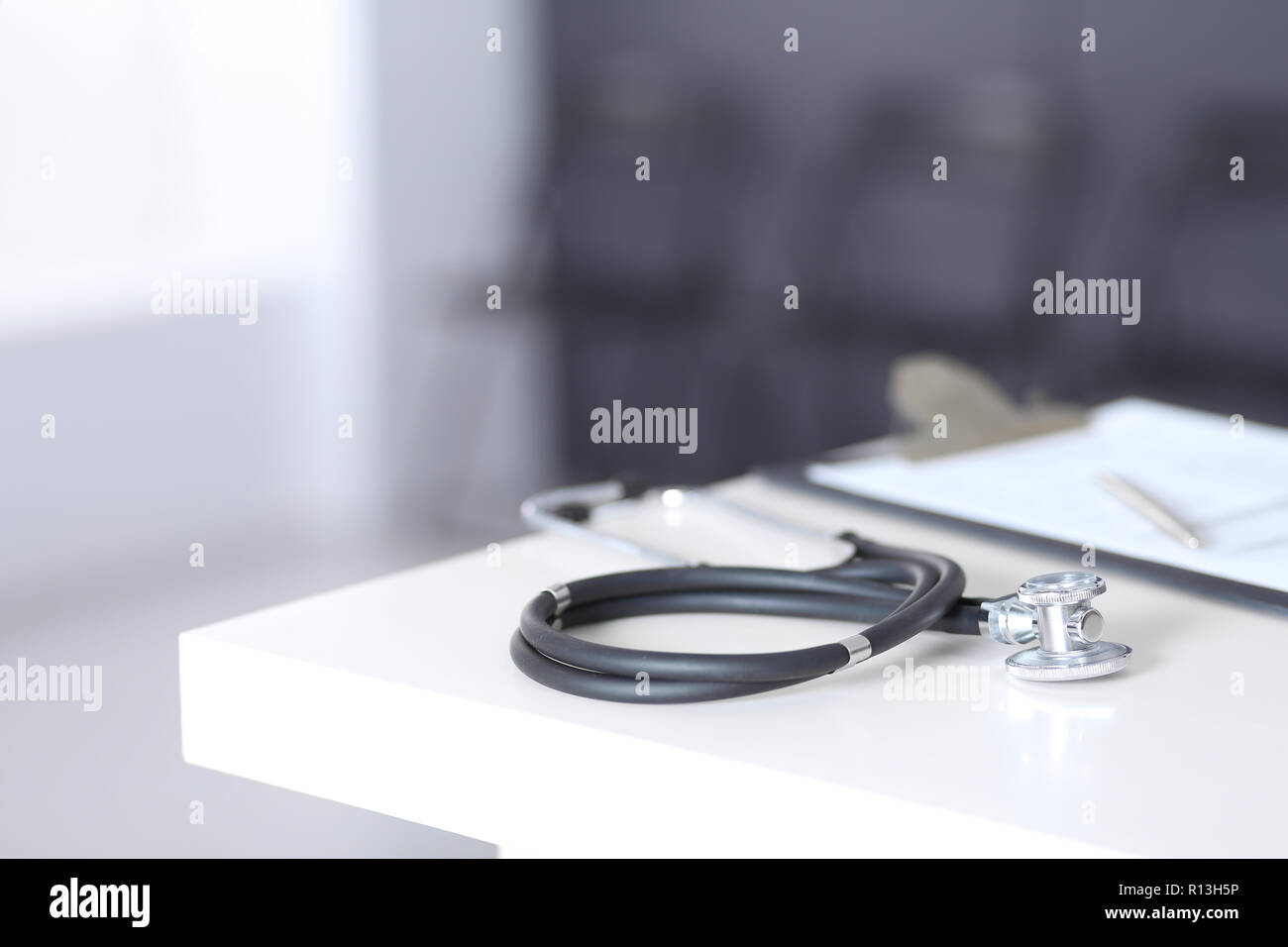 Stethoscope and medical history form lying at reception desk. Medical ...