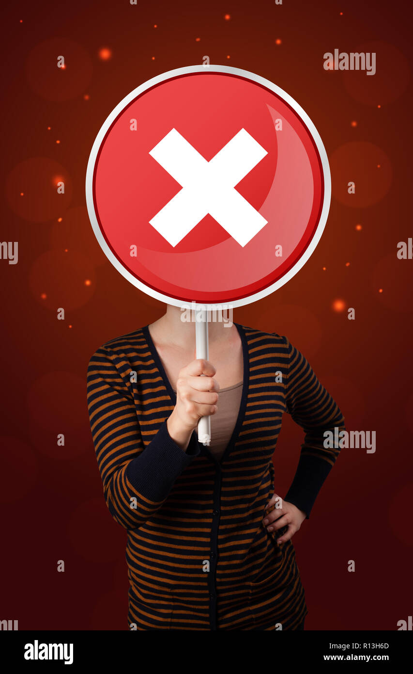 Casual young woman holding round red sign with white cross Stock Photo ...