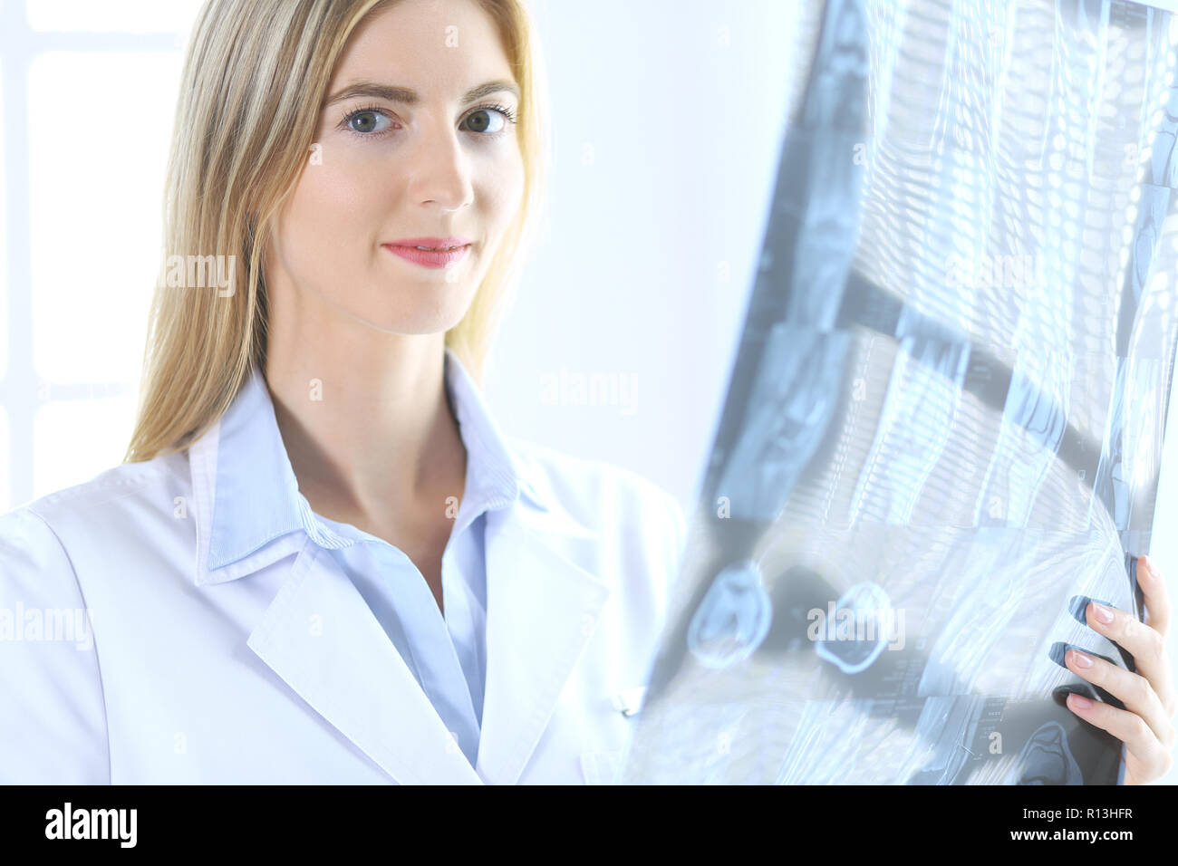 Doctor woman osteopathist examining x-ray picture while standing near ...