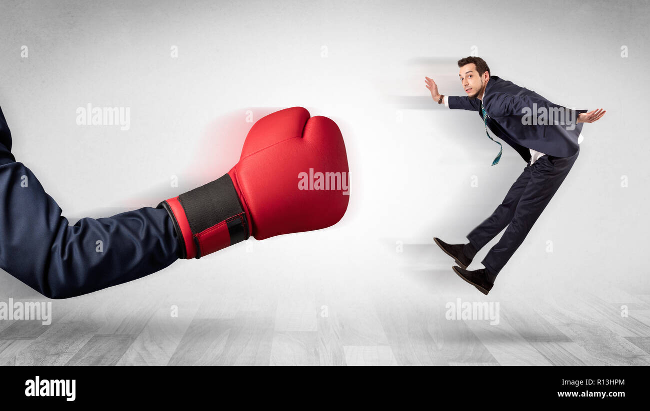 Big red boxing glove knocks out little businessman concept Stock Photo ...