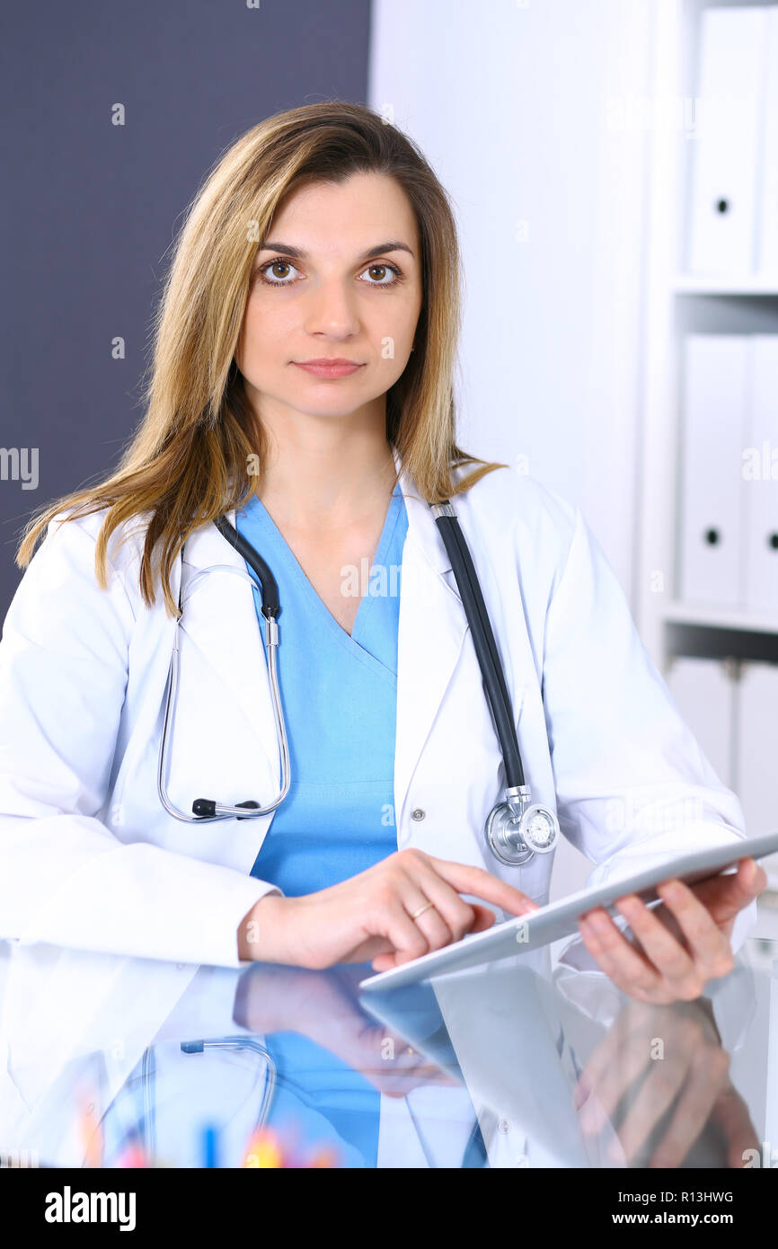 Woman doctor at work in hospital office. Portrait of female physician ...