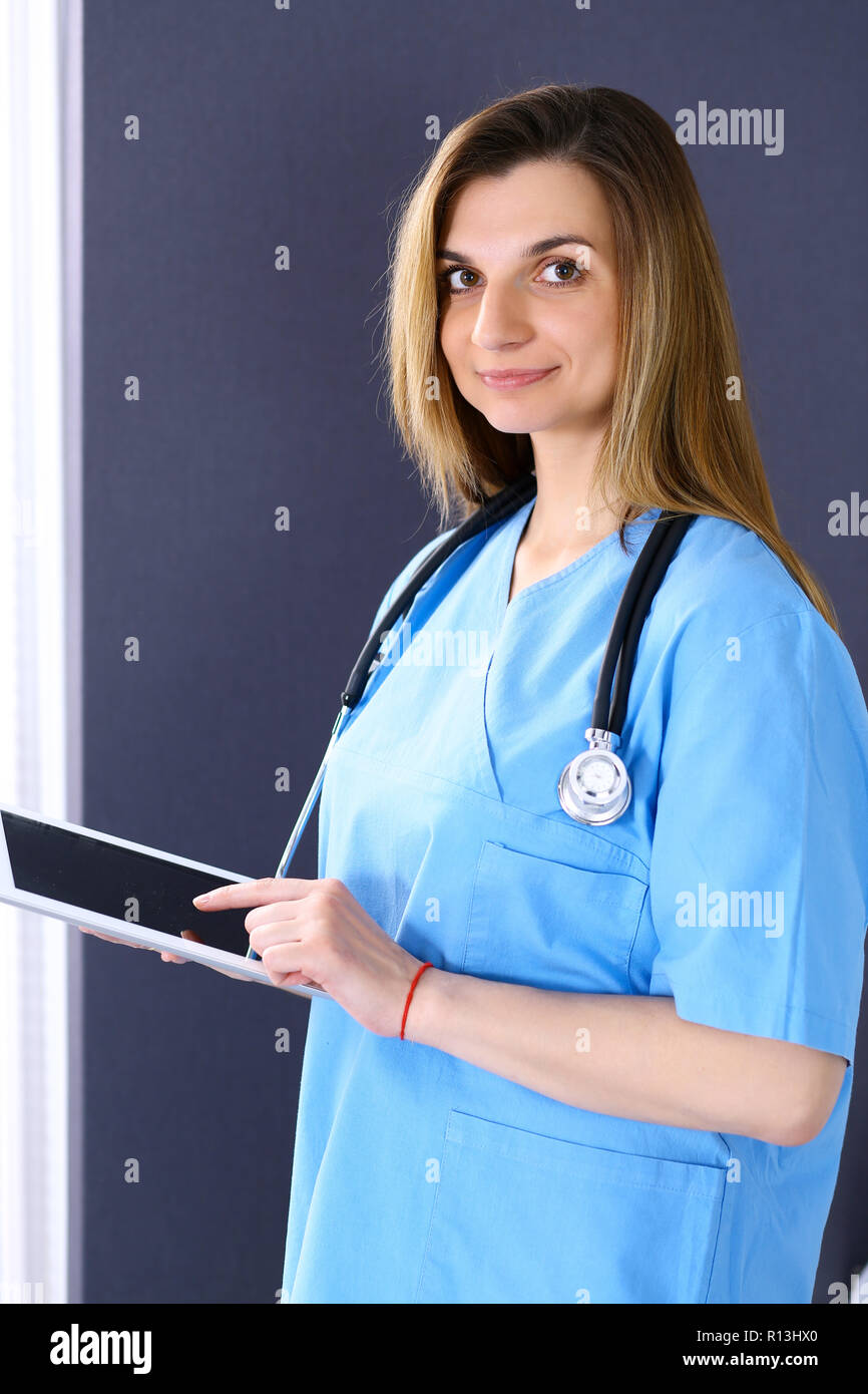 Woman doctor at work in hospital office. Portrait of female physician ...