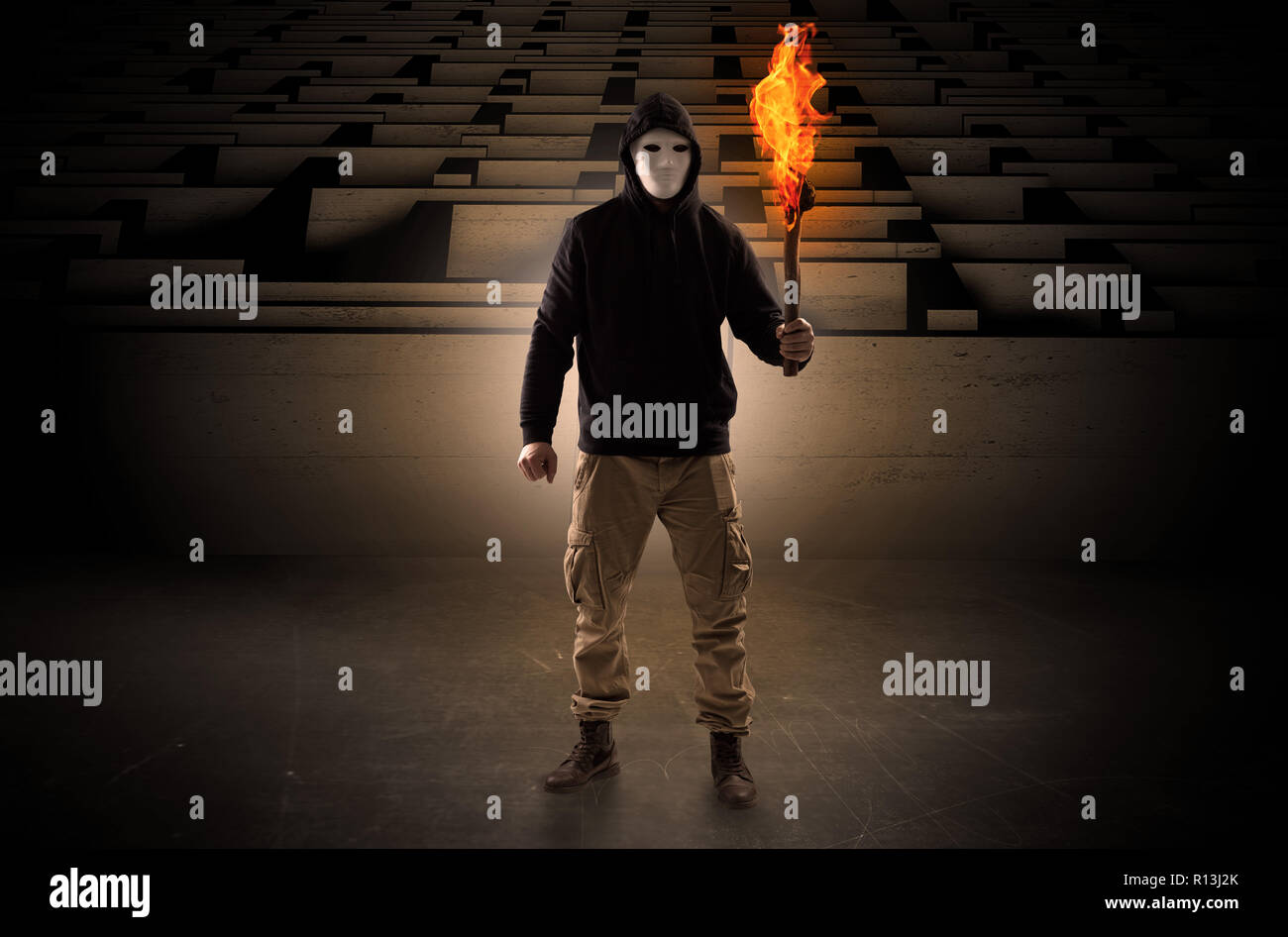 Ugly, aberrant man coming out from the labyrinth with burning flambeau ...