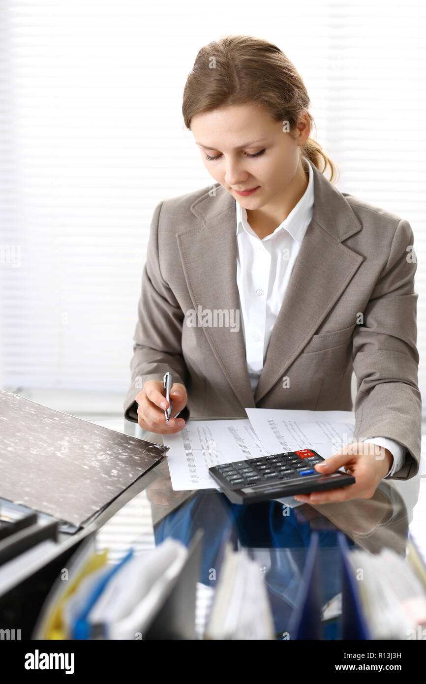 Bookkeeper woman or financial inspector making report, calculating or ...