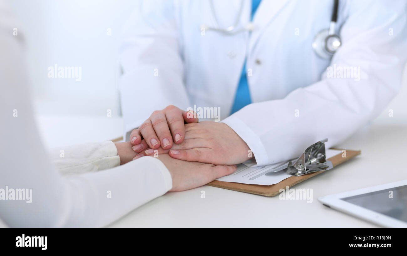 Medicine doctor hand reassuring her female patient closeup. Medicine ...