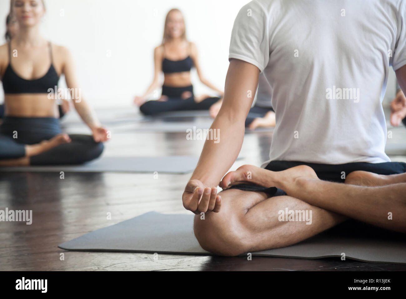 Group of sporty people in Lotus exercise, close up Stock Photo - Alamy