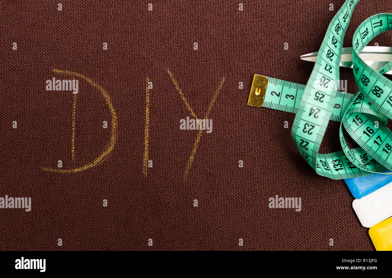 DIY text as do it yourself or handmade concept written on brown fabric ...