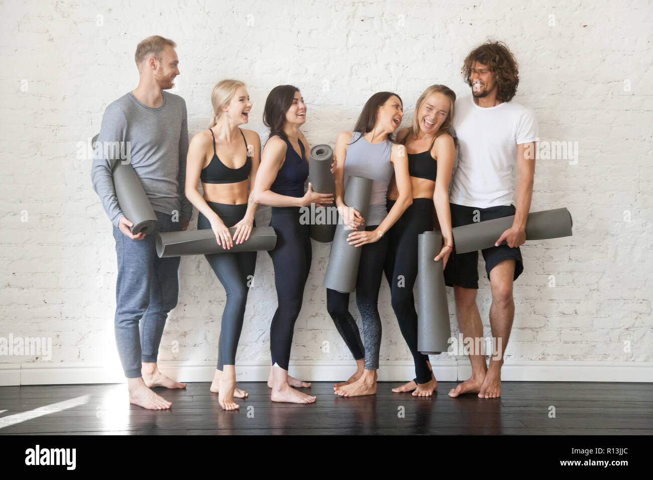 Portrait of laughing fit people with exercise mats Stock Photo - Alamy