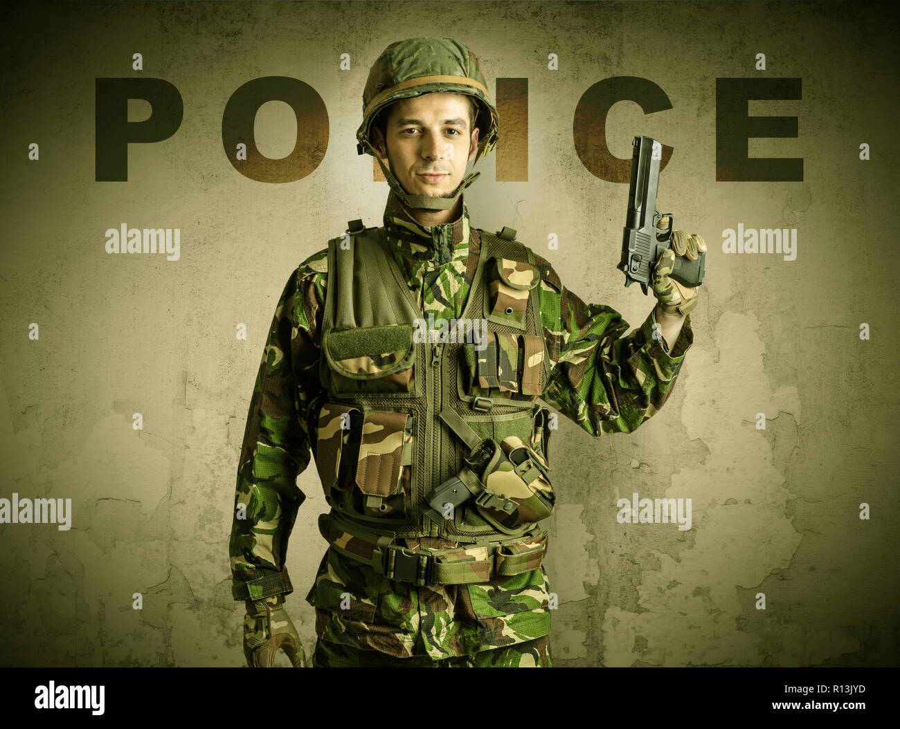 Uniformed armed soldier with damaged wall background Stock Photo - Alamy
