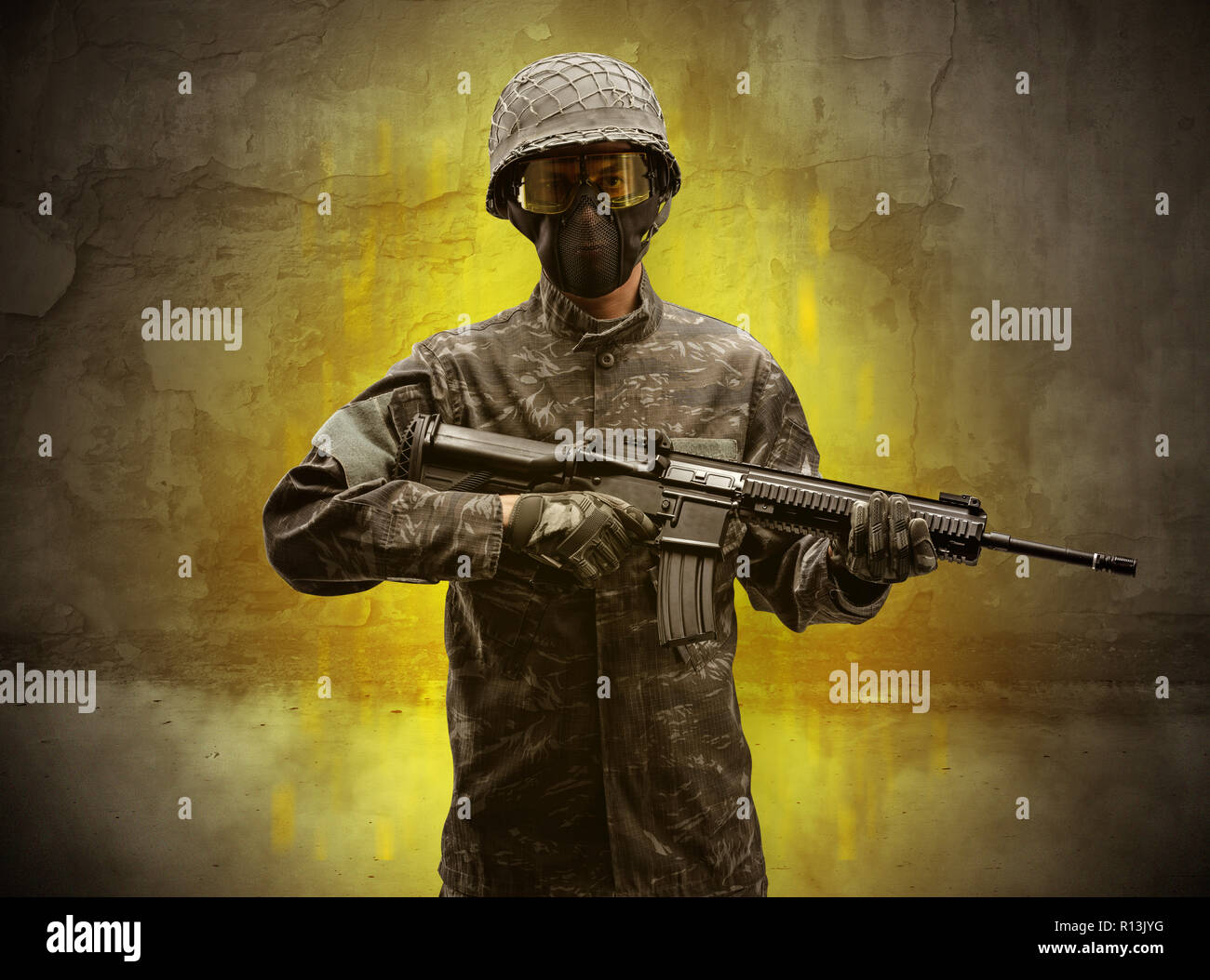 Hazard, menace soldier in a ruined crumbly building with arms on his ...