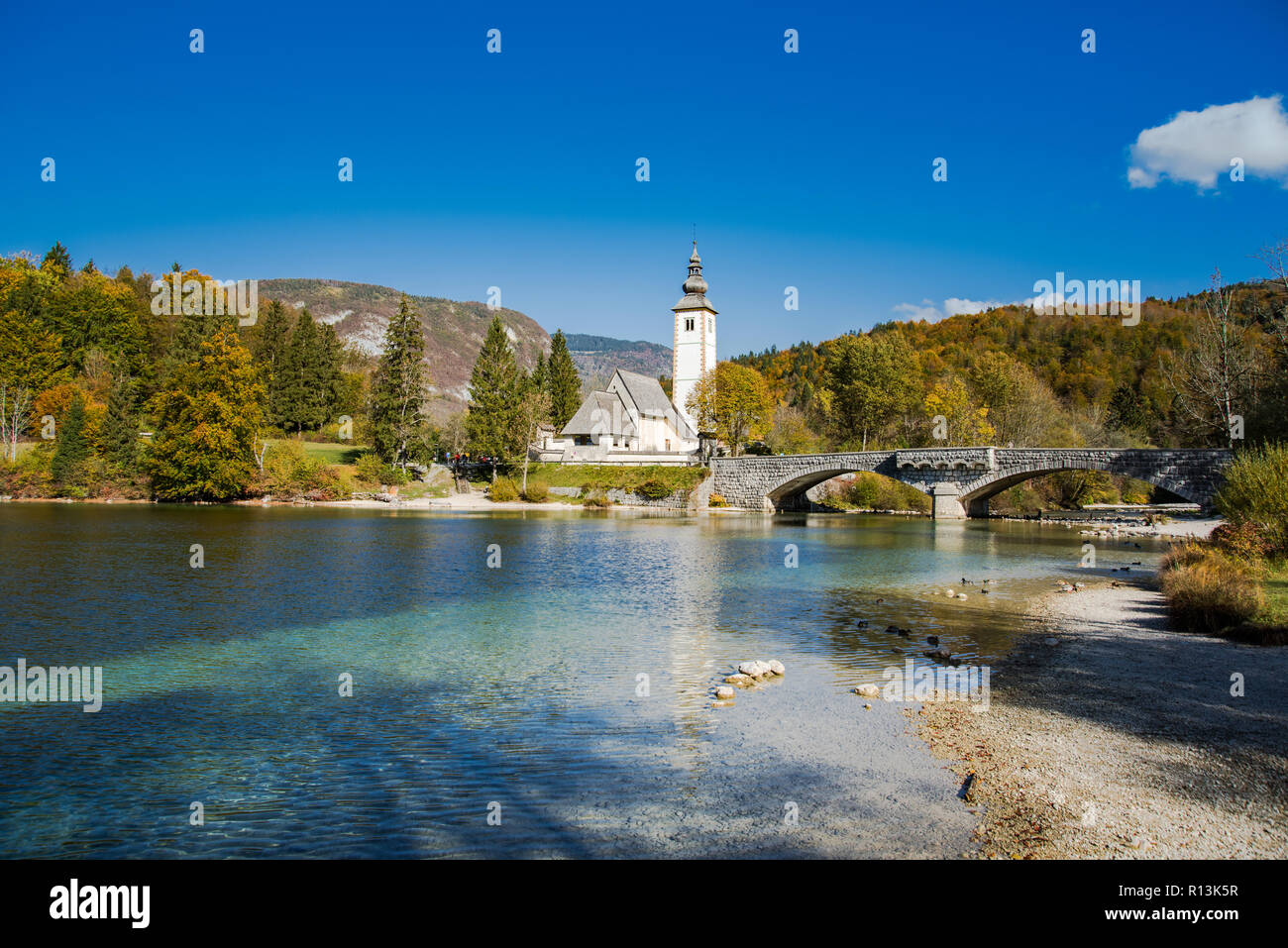 Gothic Church of St. John the Baptist and stone bridge in Ribcev Laz ...