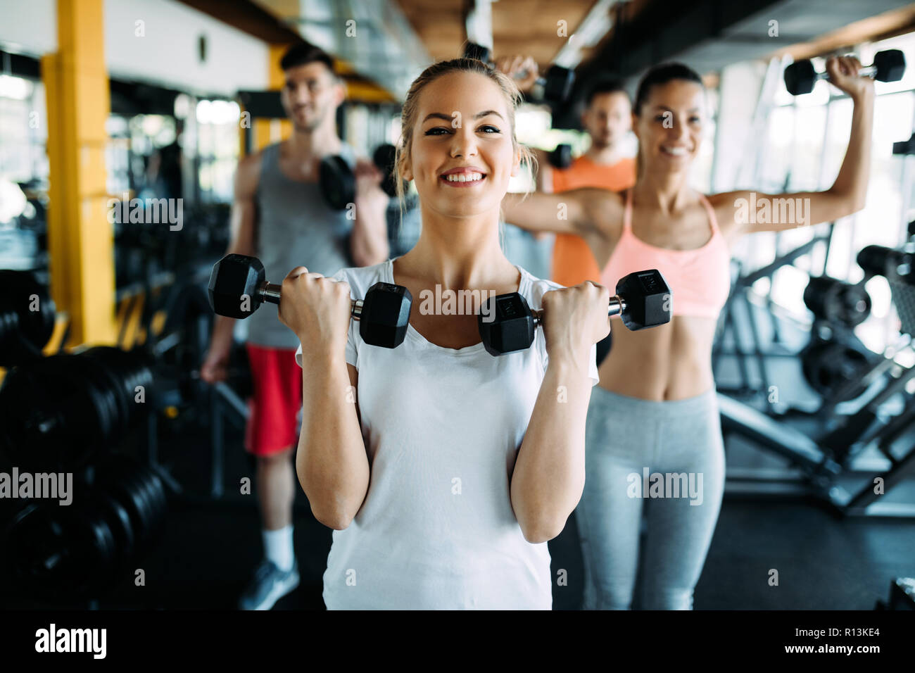 Group friends flexing muscles together hi-res stock photography and ...